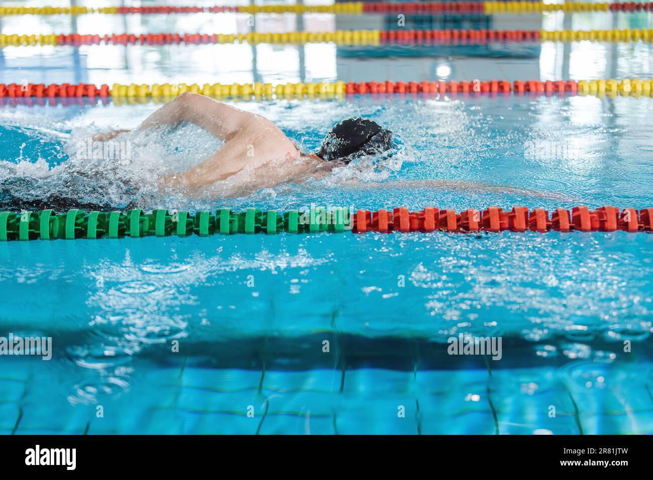 Professional male swimmer swimming the front crawl style. Freestyle ...