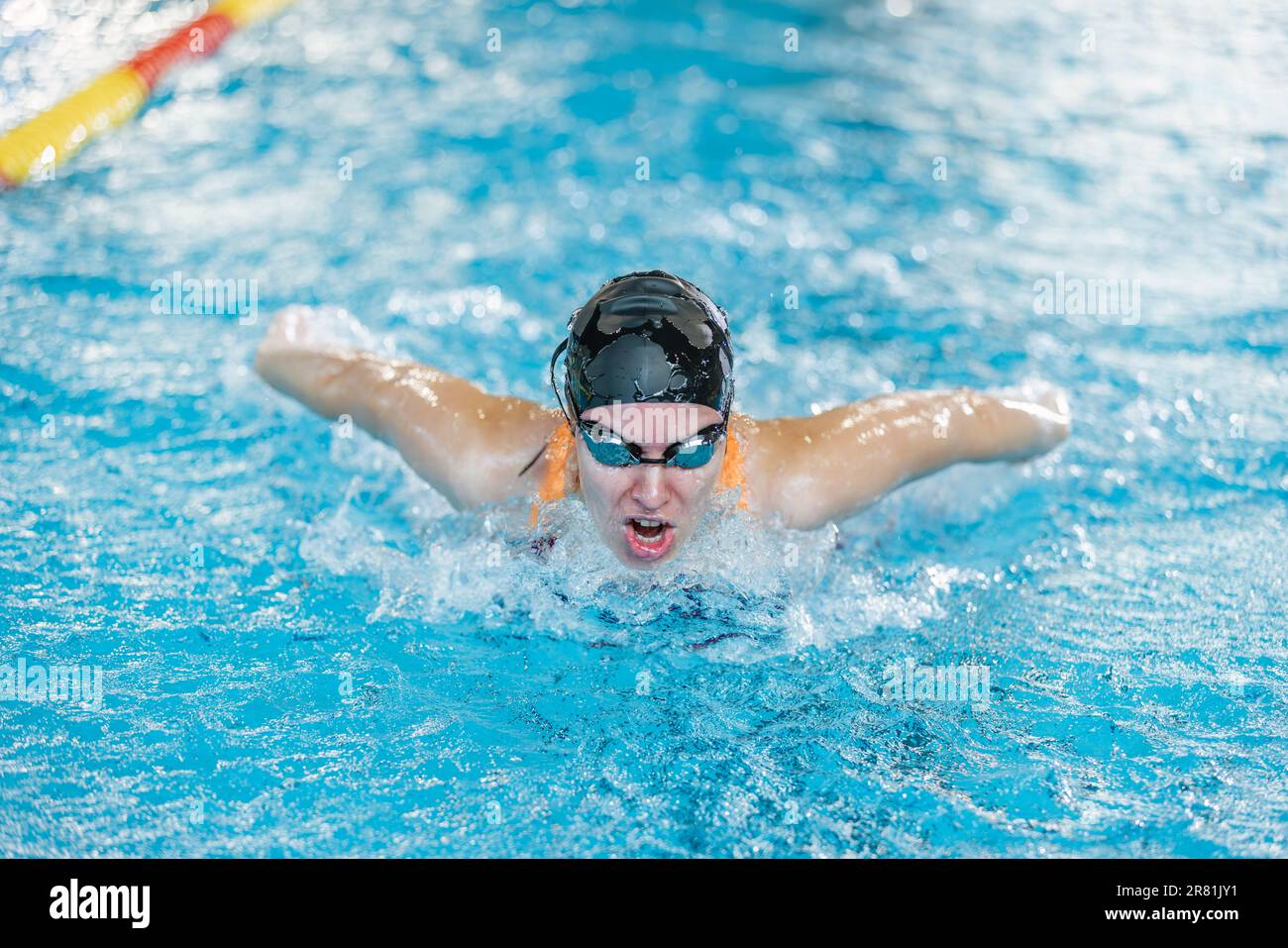 Female competitive swimmer moving through the water performing the ...