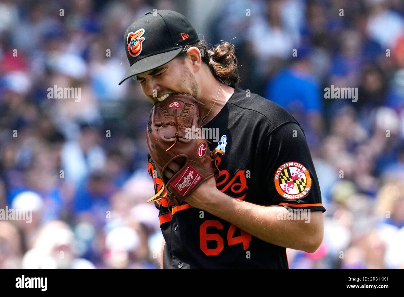 Baltimore Orioles starting pitcher Dean Kremer bites his glove while he ...