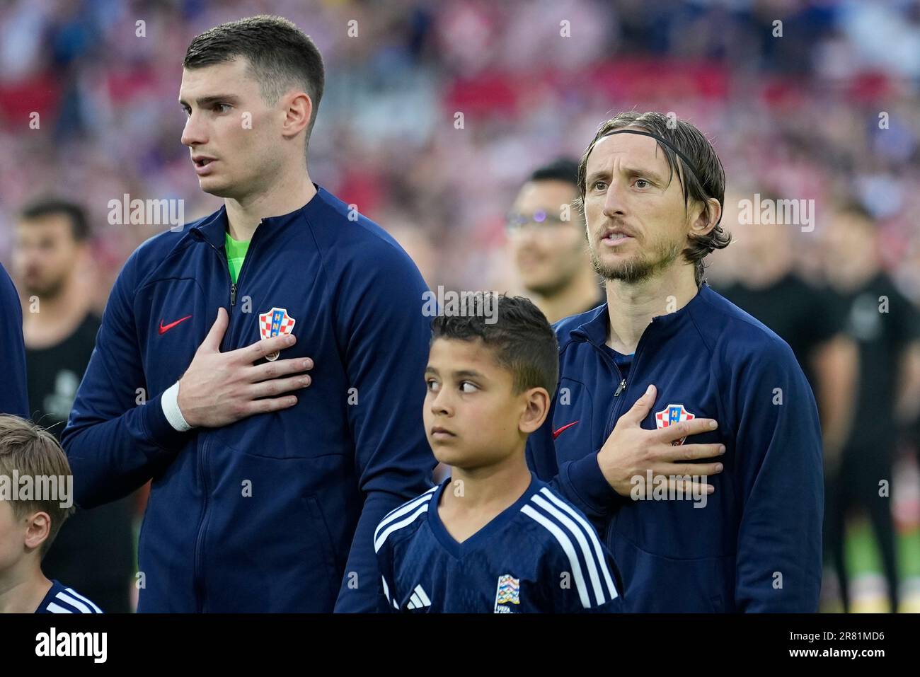 Croatia's Luka Modric, left, Croatia goalkeeper Dominik Livakovic line ...