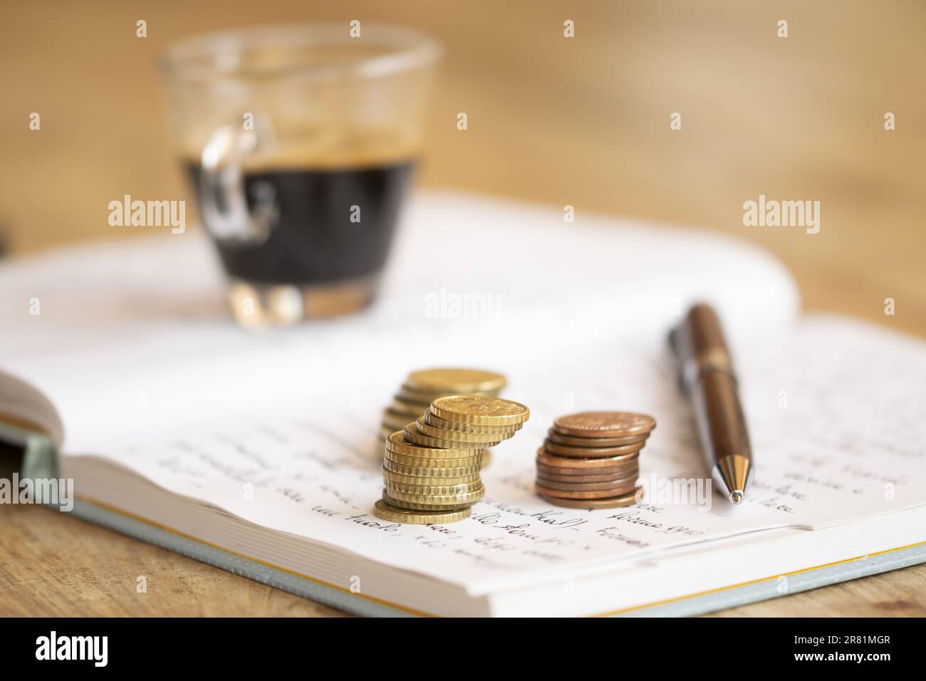 home accounting concept with coins and a hand notebook register Stock ...