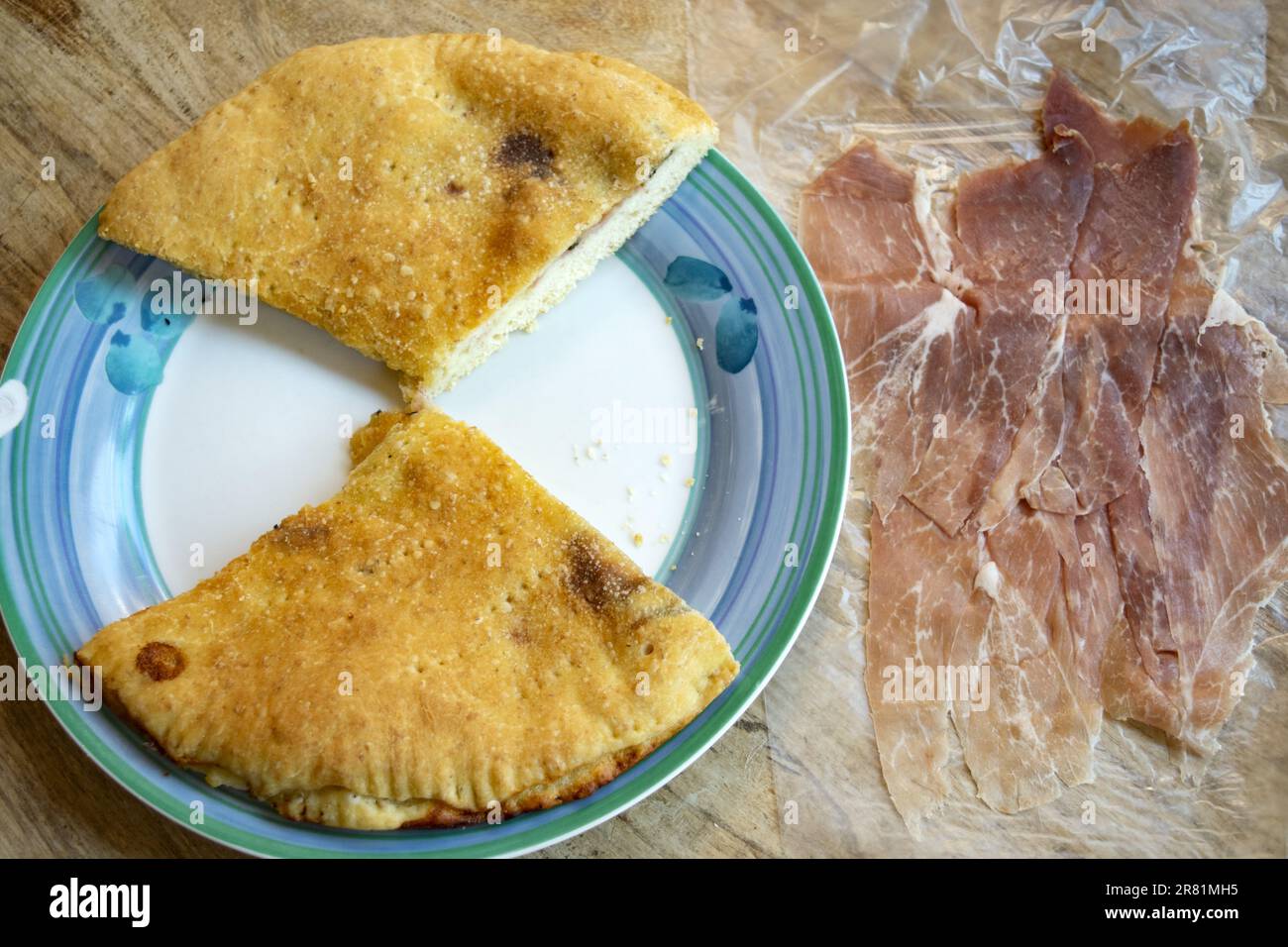 white pizza stuffed with parma ham and cheese Stock Photo - Alamy