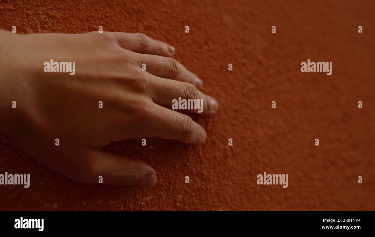 closeup man hand touching terracotta wall, wide photo Stock Photo - Alamy