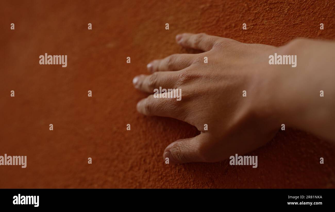 closeup man hand touching terracotta wall, wide photo Stock Photo - Alamy