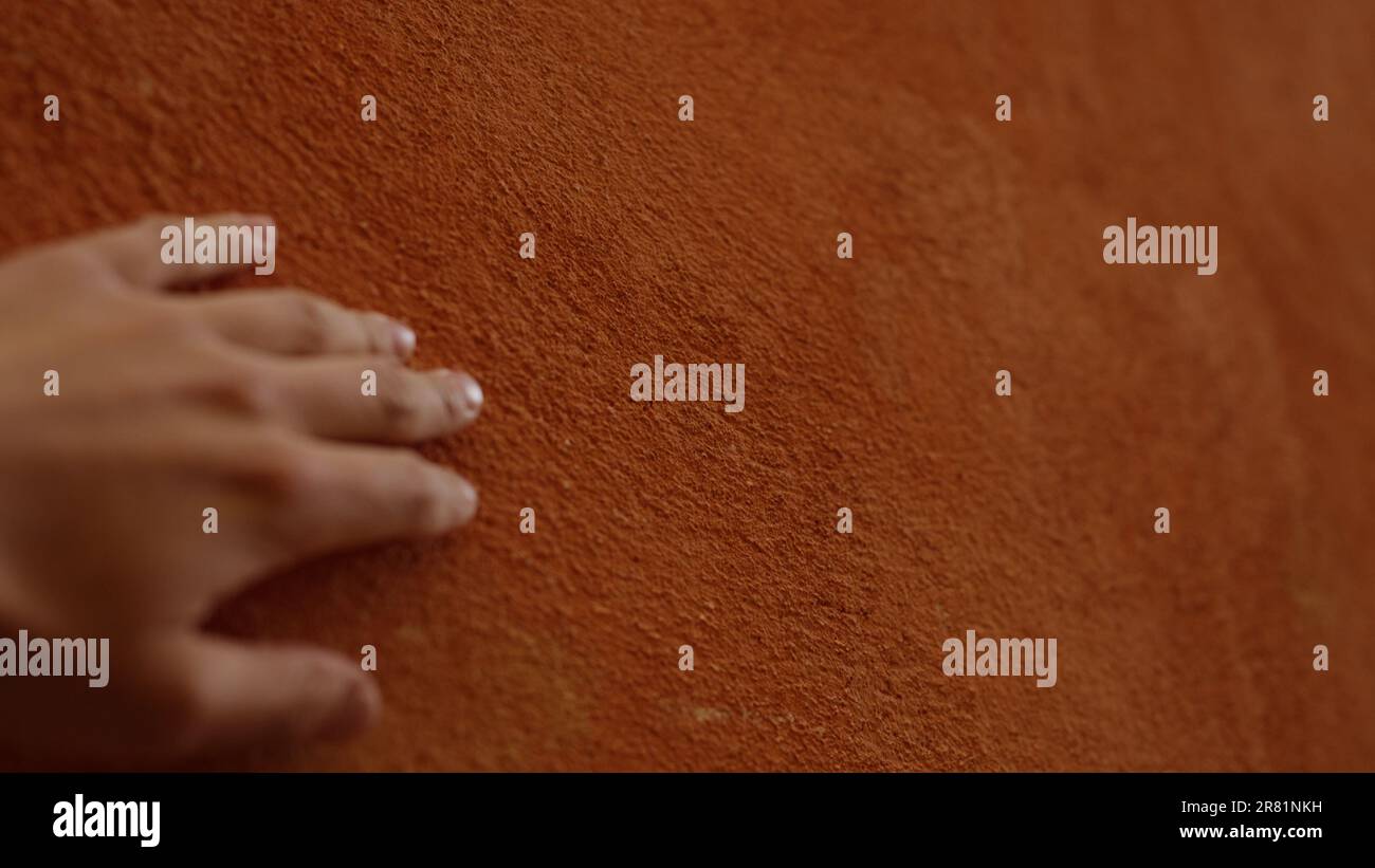 closeup man hand touching terracotta wall, wide photo Stock Photo - Alamy