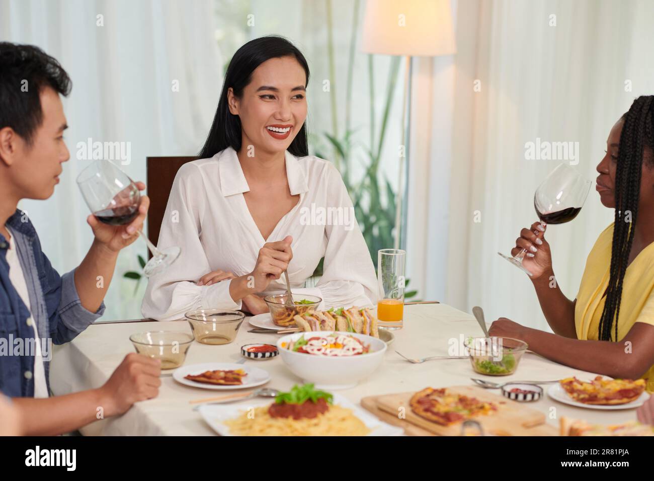 Happy woman hosting birthday party at home Stock Photo - Alamy