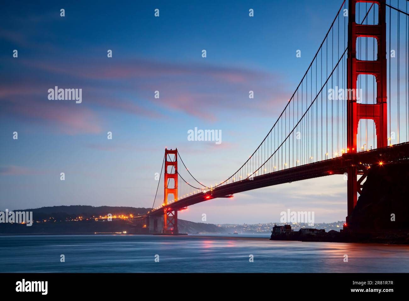 A spectacular view of the Golden Gate Bridge, illuminated in the night ...