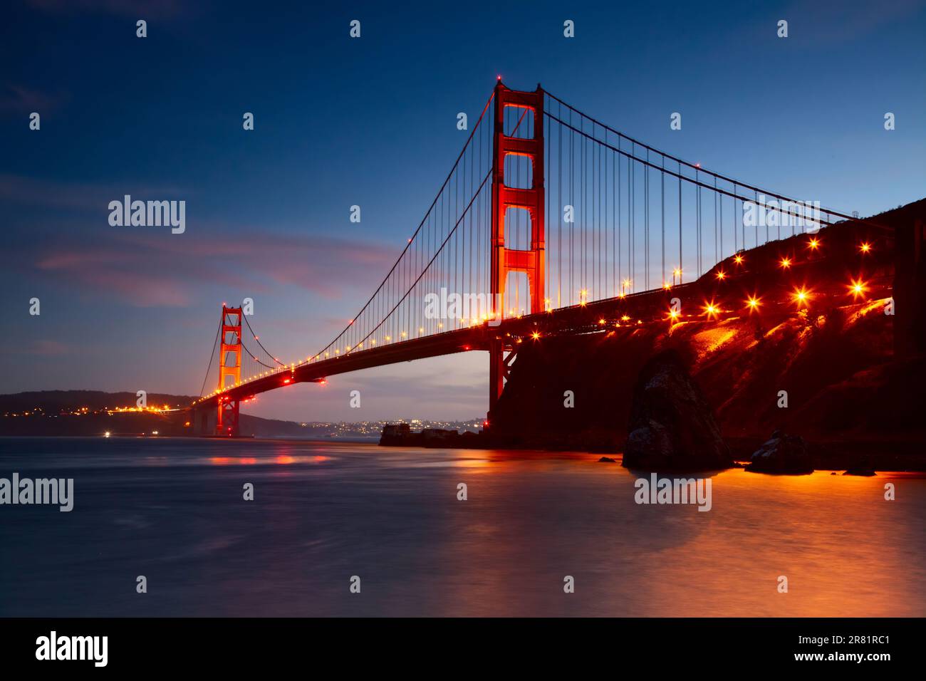 A spectacular view of the Golden Gate Bridge, illuminated in the night ...