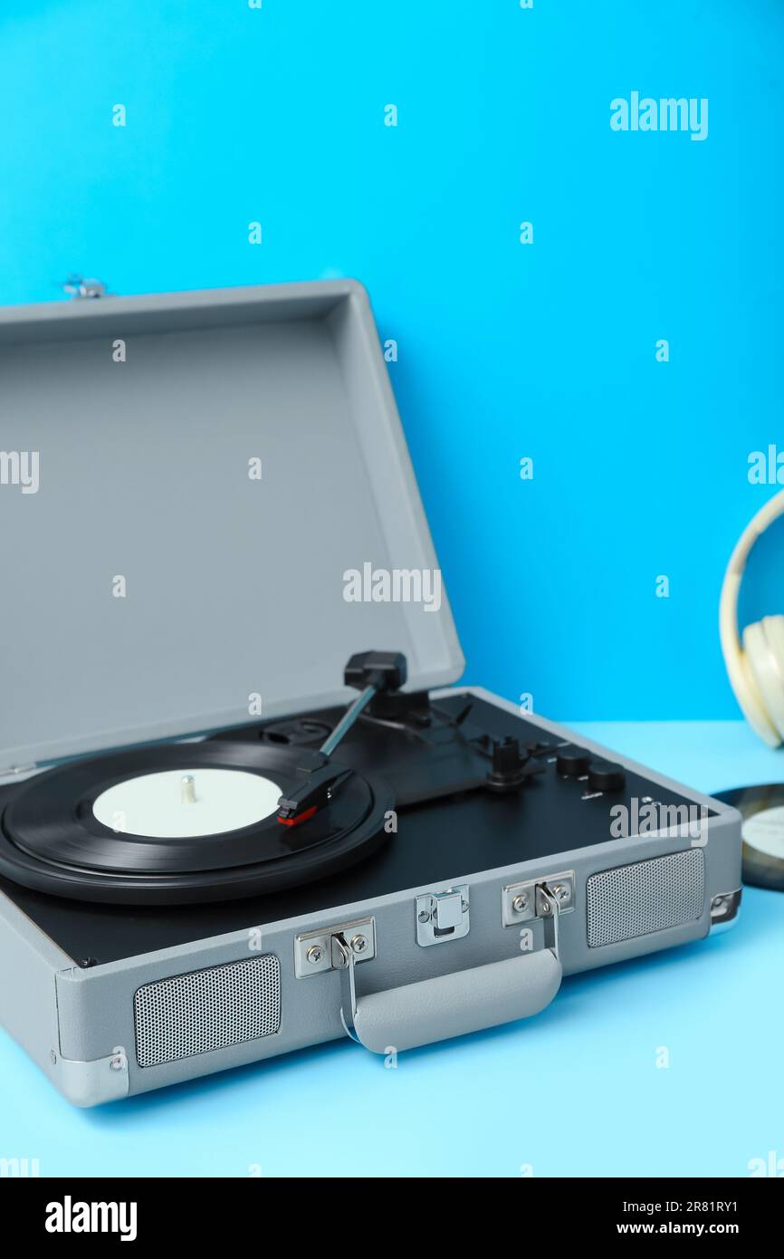 Record player with vinyl disk on blue table Stock Photo - Alamy