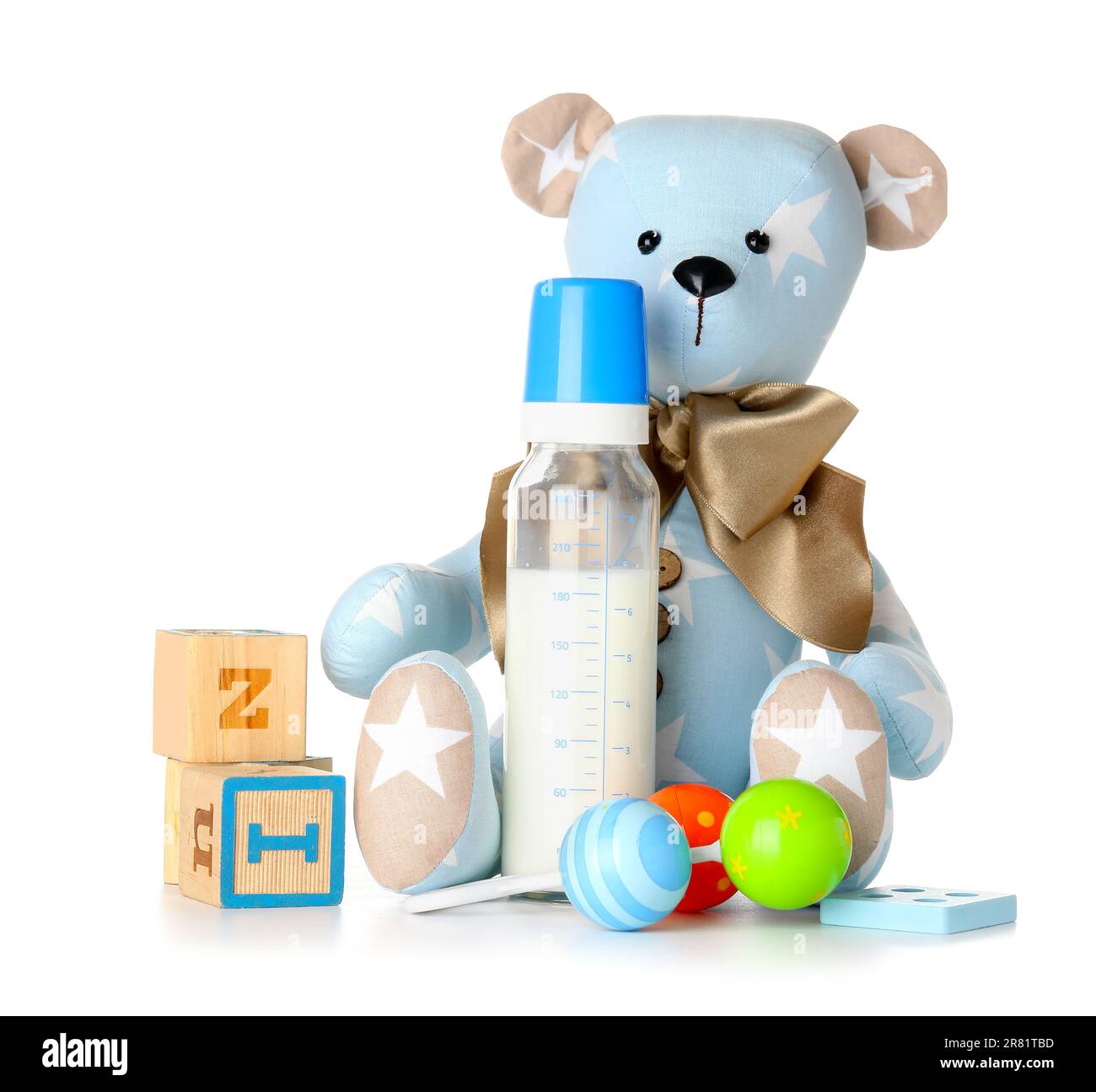 Teddy bear with bottle of milk for baby with toys on white background ...