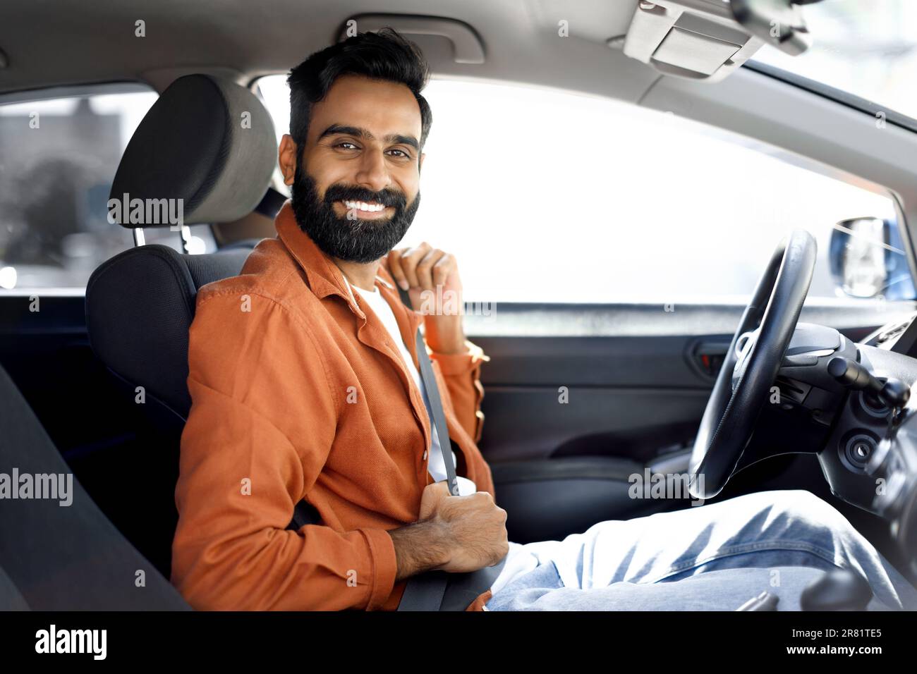 Smiling Middle Eastern Driver Man Fastening Seat Belt In Auto Stock ...