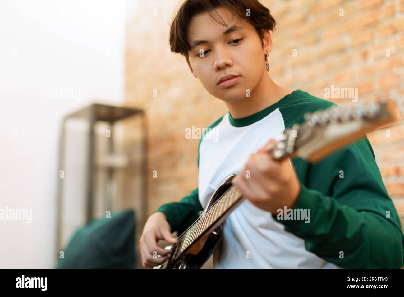 Asian Teenager Guy Practicing Guitar Indoor, Playing Electric Musical ...