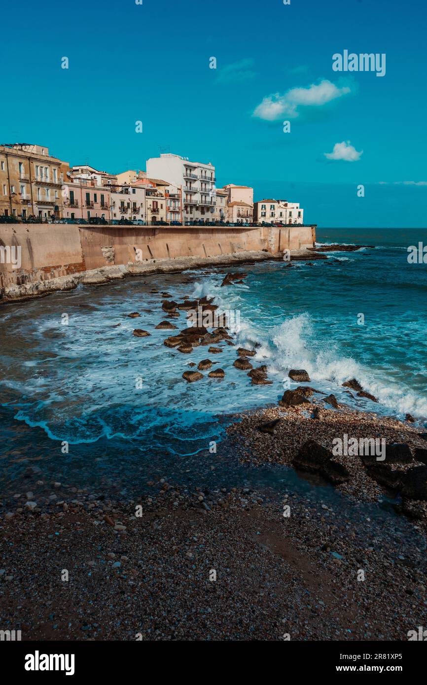 A picturesque beach with a beautiful, buildings in the background Stock ...