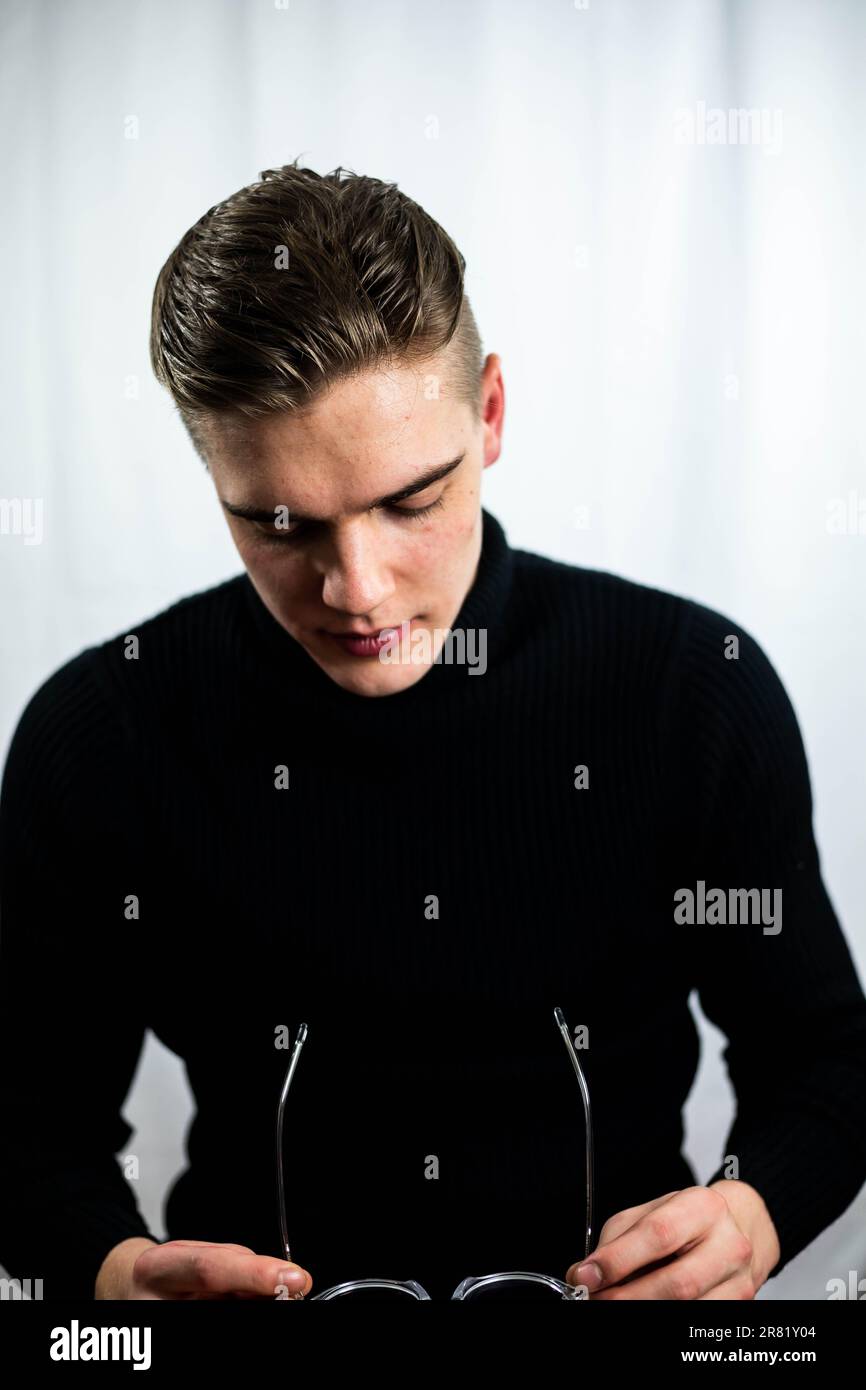 A young Caucasian adult male looking down in concentration while ...