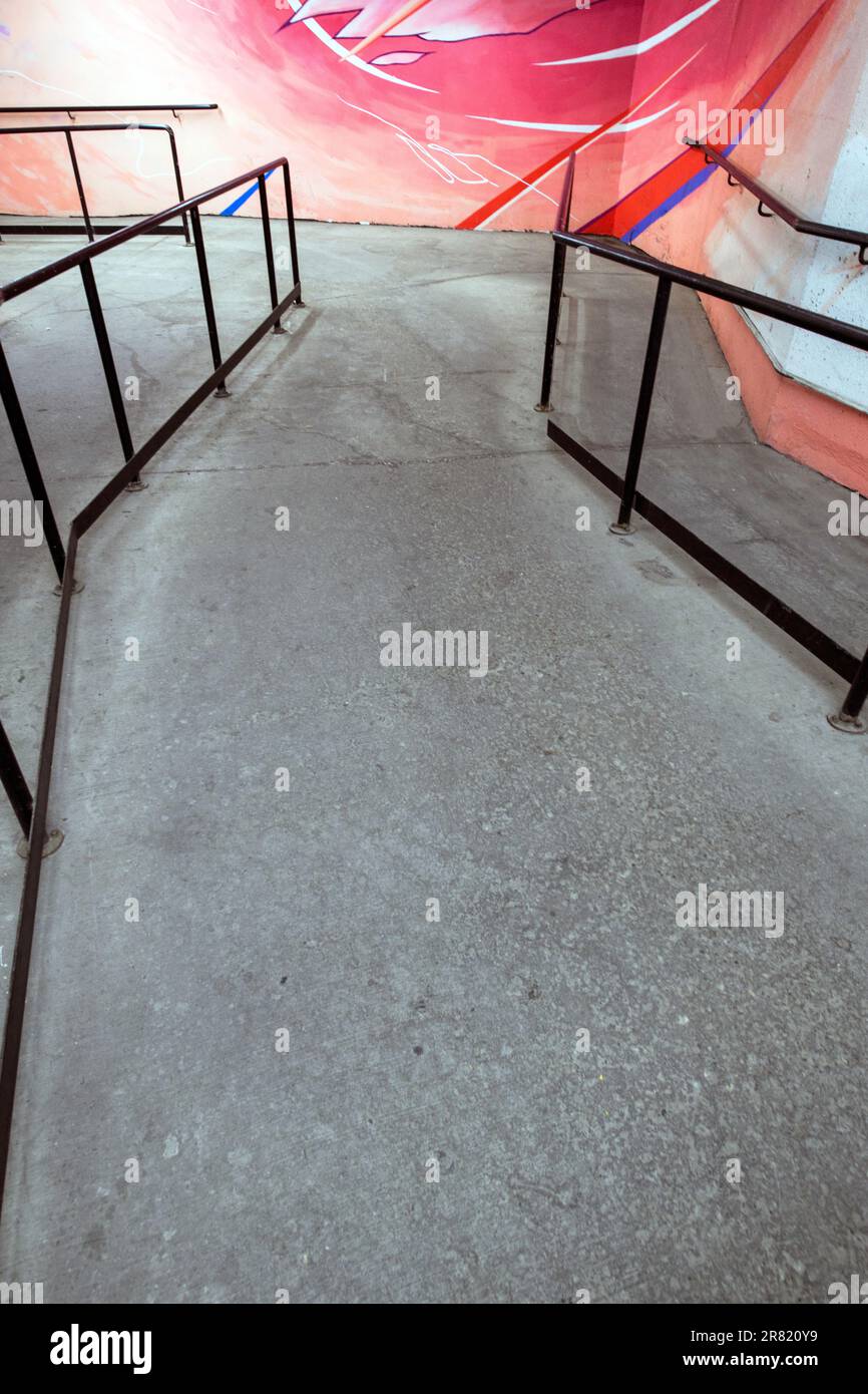 Handicapped down ramp with urban art on walls Stock Photo - Alamy