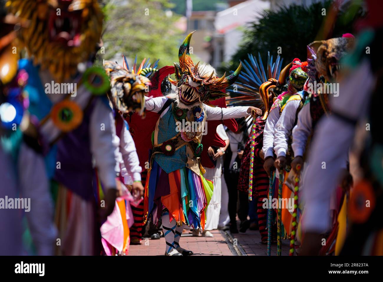 Dancers wearing devil masks perform during a Corpus Christi procession ...