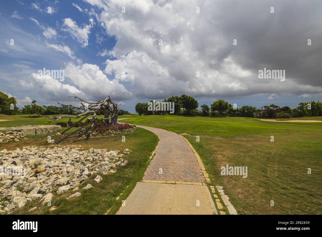 Beautiful golf course view with tropical flower bed design with dried ...