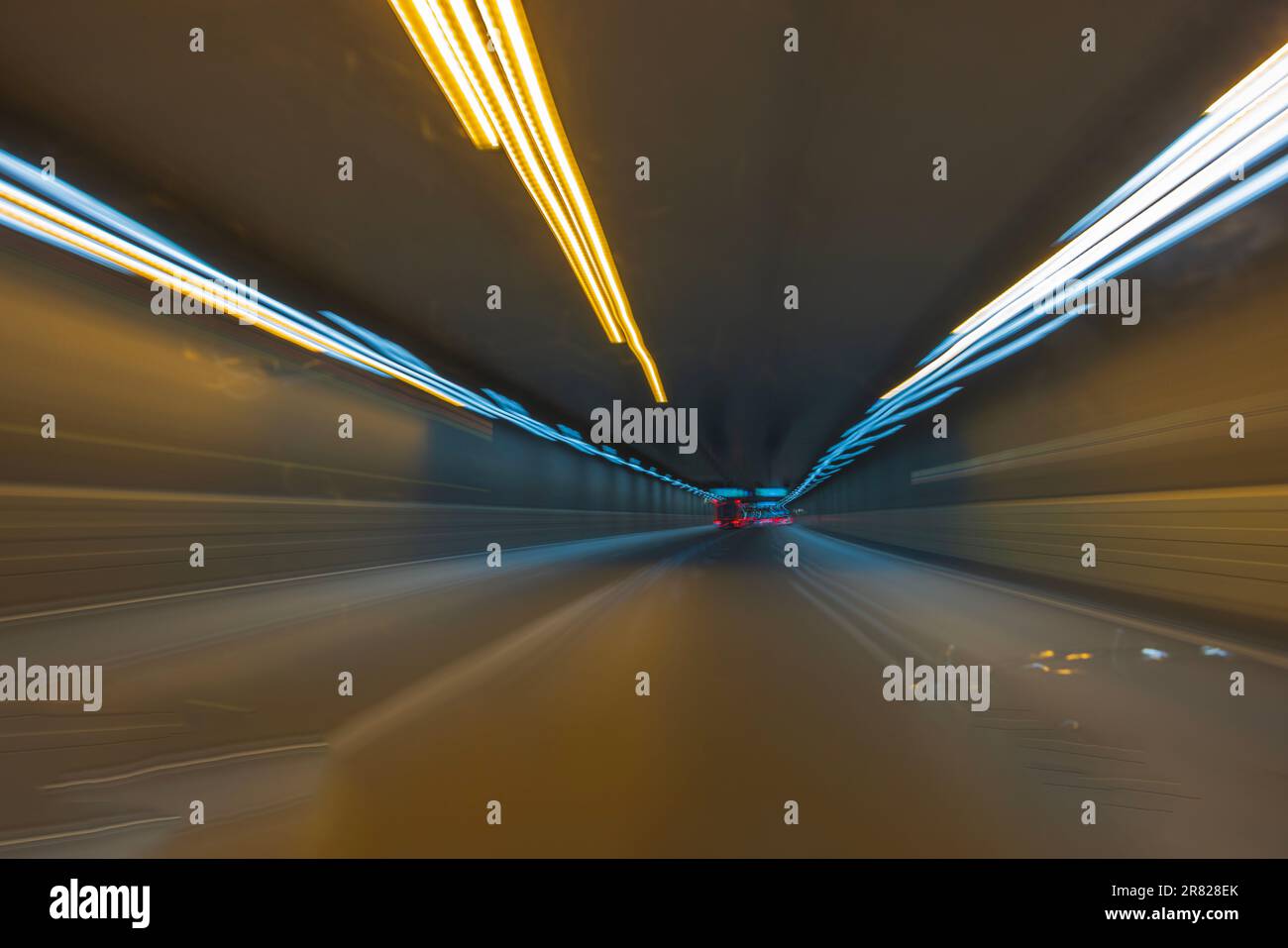 Gorgeous out-of-focus colorful tracers of tunnel road lights. Abstract ...