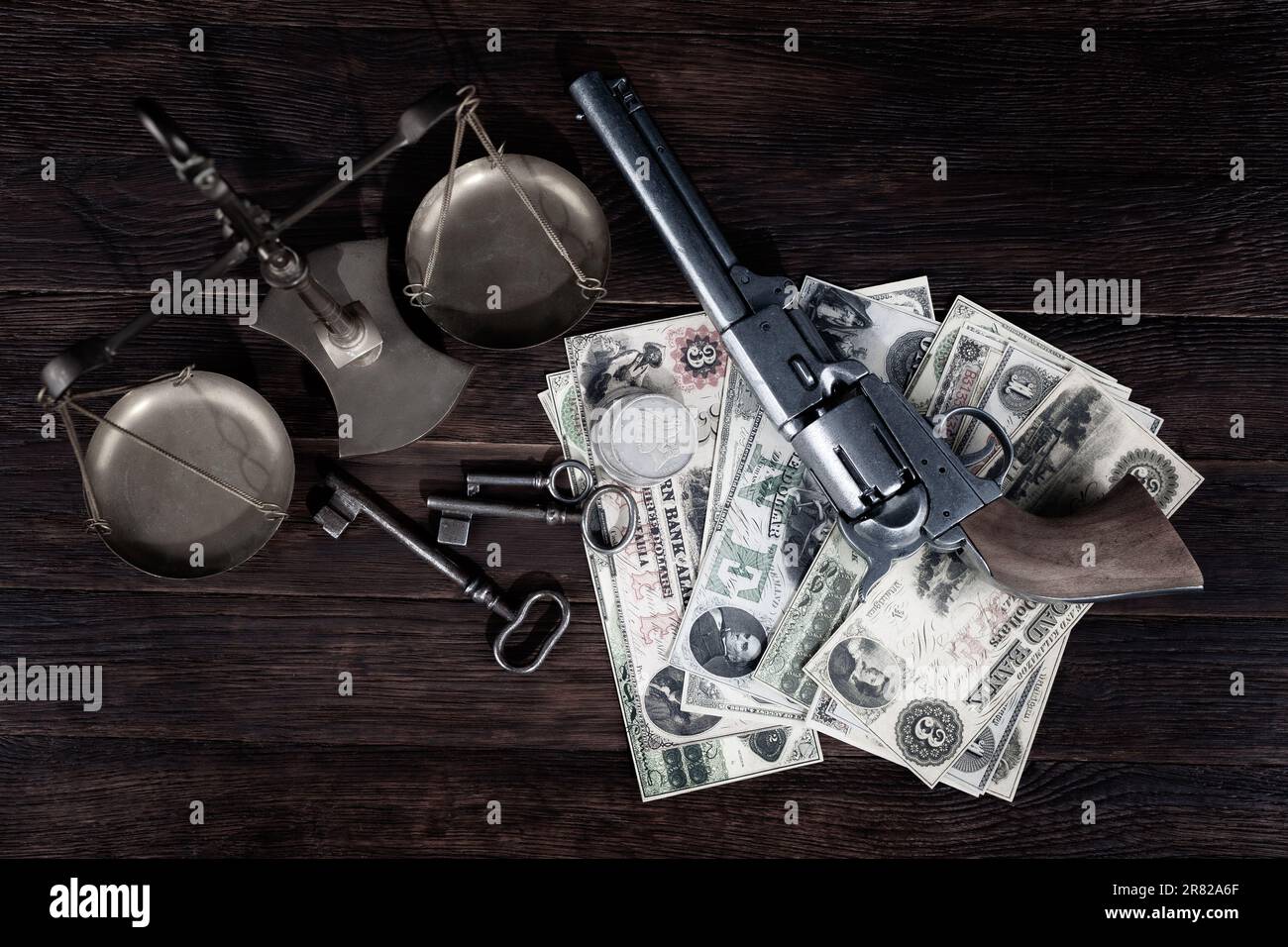 Old west Colt revolver and US banknotes and silver certificates with ...