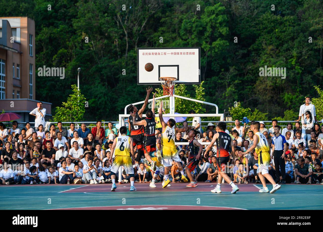 Players compete on a basketball court at a resettlement area in Pomei ...