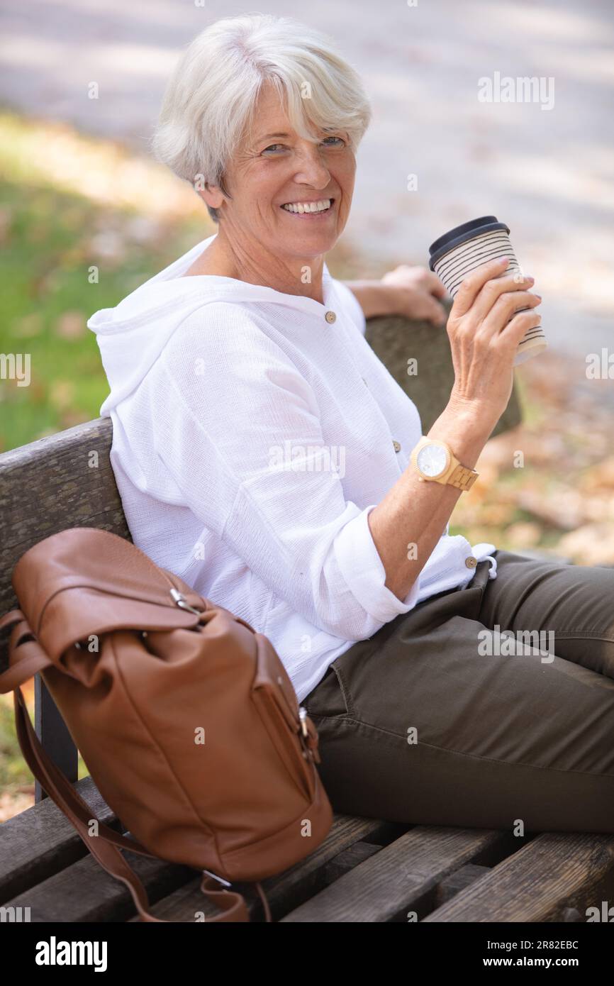 old lady drinking coffee in park Stock Photo - Alamy