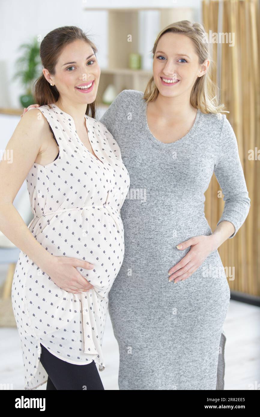 Woman and friend touching baby bump hi-res stock photography and images ...