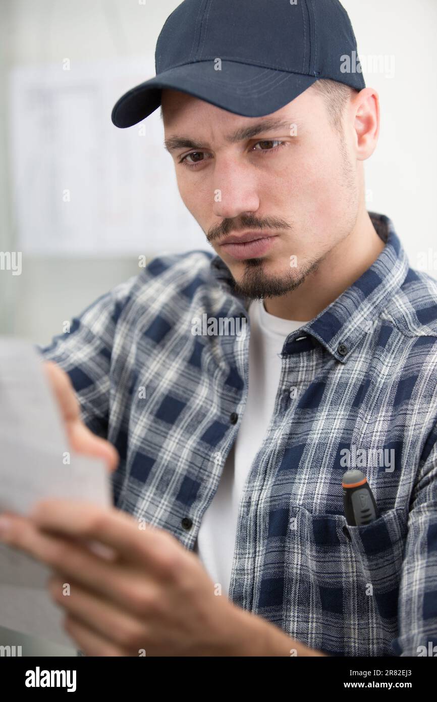 male worker reading instruction Stock Photo - Alamy