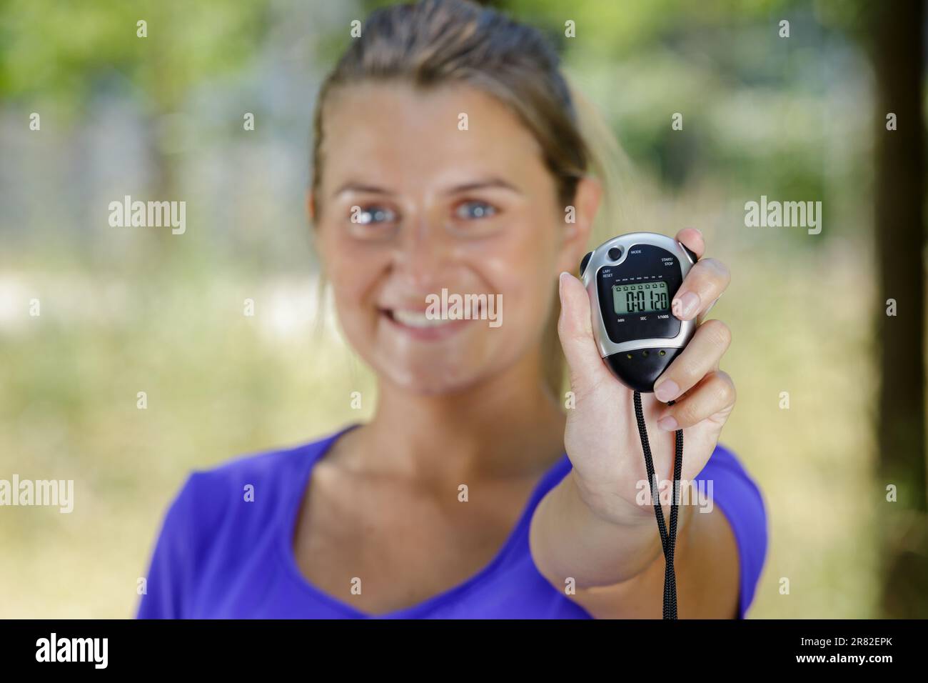 happy woman showing a stopwatch Stock Photo - Alamy