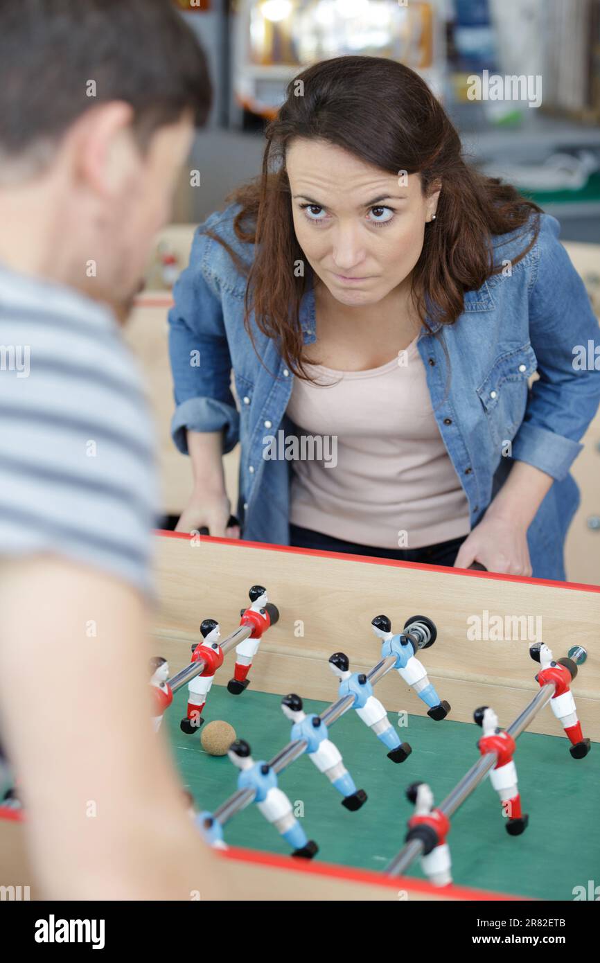 friends having fun together playing table football Stock Photo - Alamy