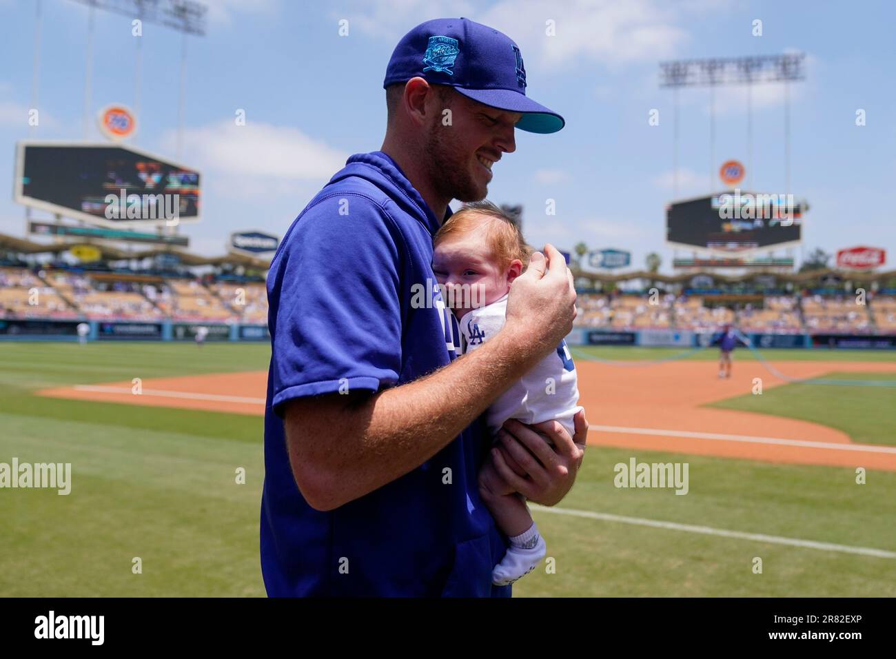 Los Angeles Dodgers relief pitcher Caleb Ferguson (64) holds his son ...