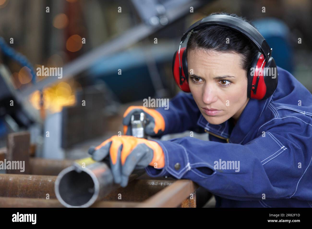 female worker measuring metal pipe Stock Photo - Alamy