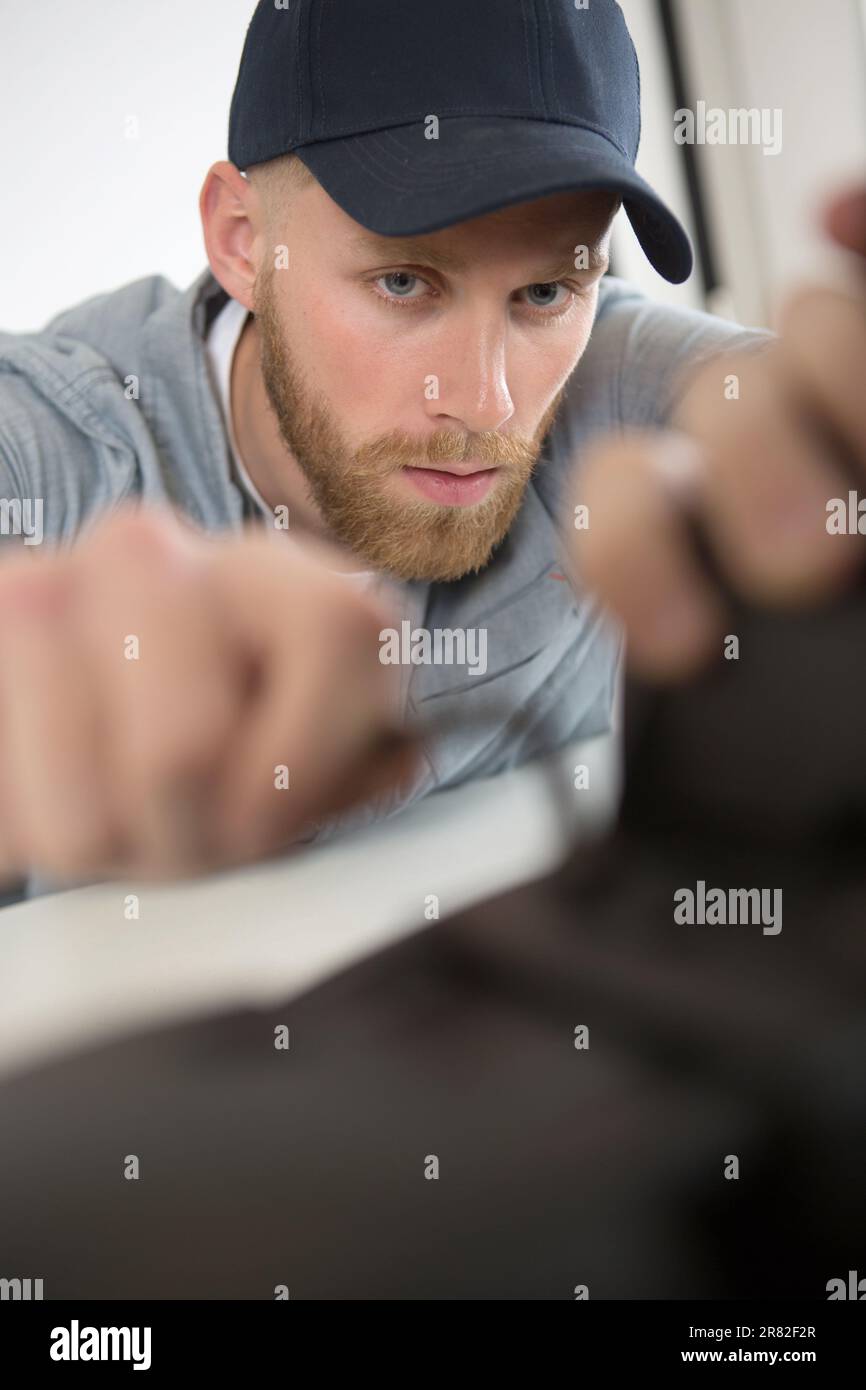 concentrated repairman repairing a device Stock Photo - Alamy