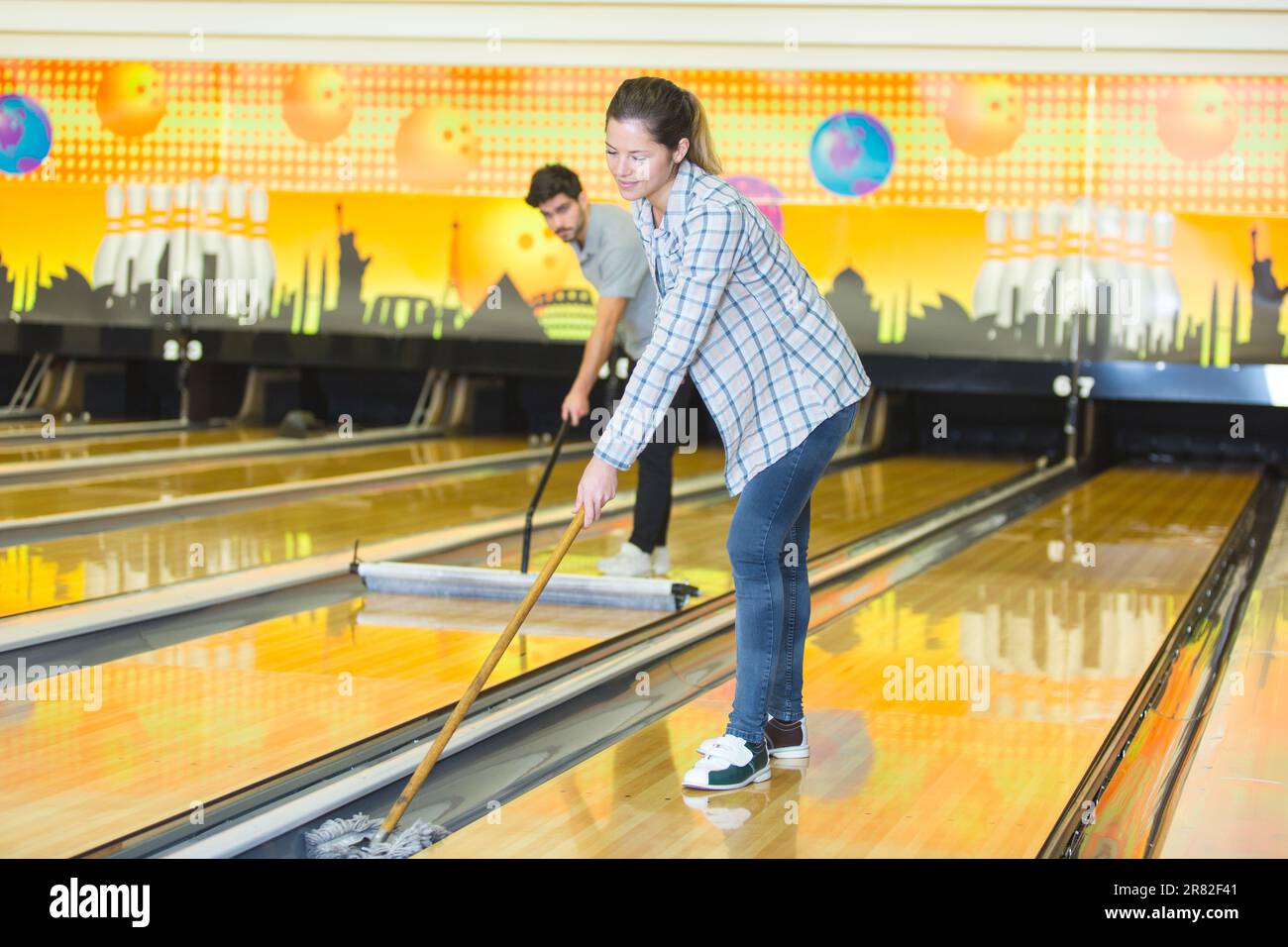 male and female workers cleaning bowling alleys Stock Photo - Alamy