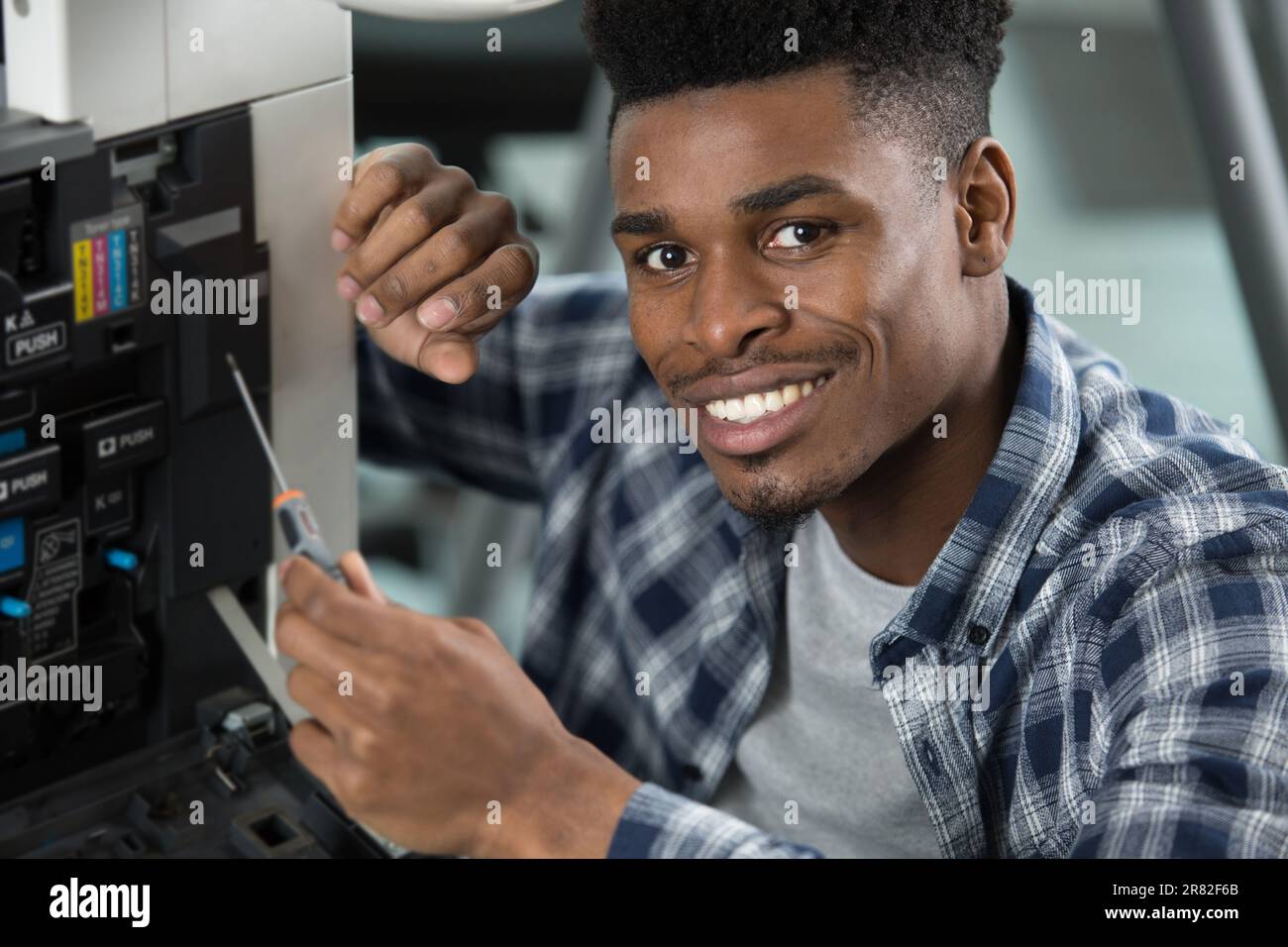 happy man fixing a printer Stock Photo - Alamy