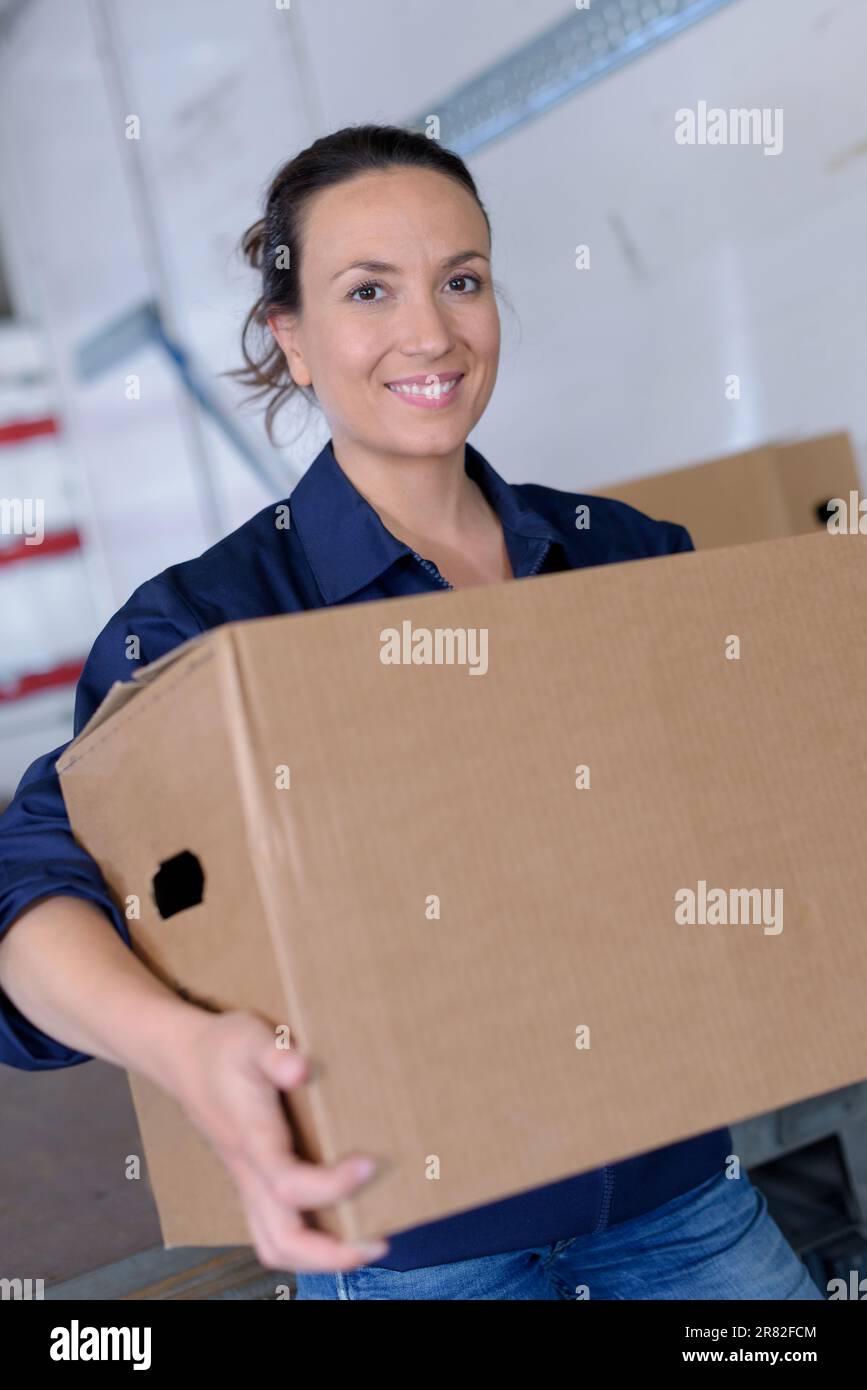 Woman delivering fragile box in hi-res stock photography and images - Alamy
