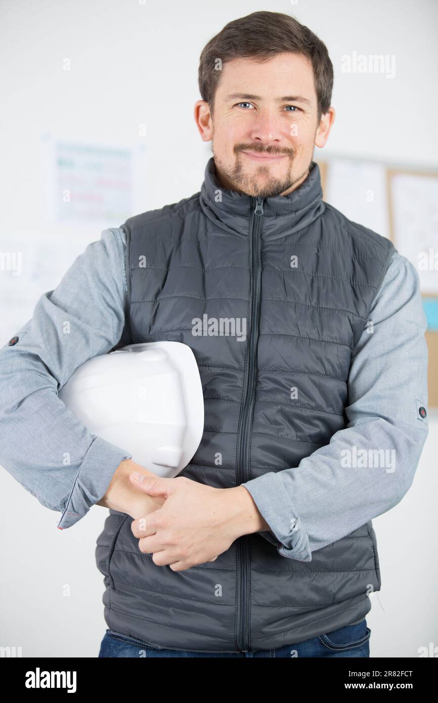 portrait of a male tradesman holding a safety helmet Stock Photo - Alamy