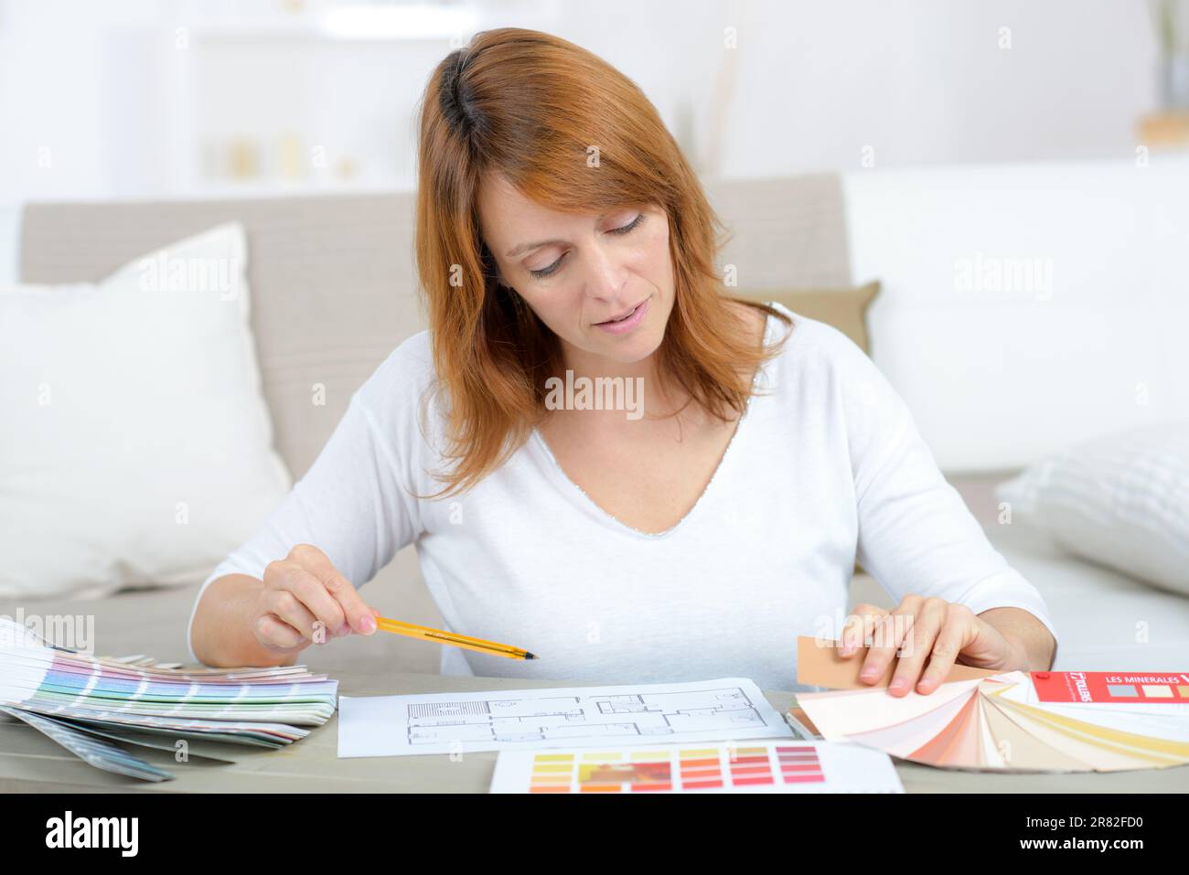 Woman looking at a colour chart Stock Photo - Alamy