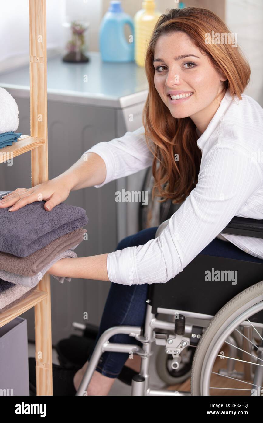 happy disable woman doing the laundry Stock Photo - Alamy
