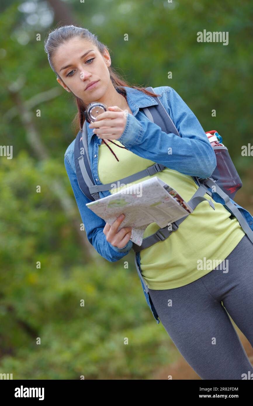 hiker with compass and reading map in the nature Stock Photo - Alamy