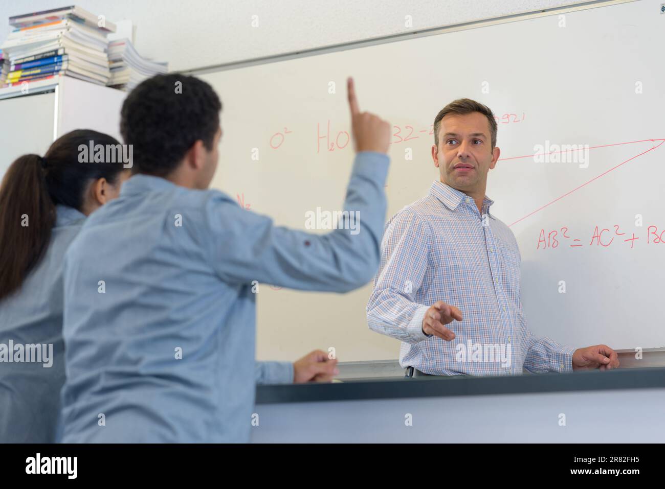 student raising his hand during class Stock Photo - Alamy