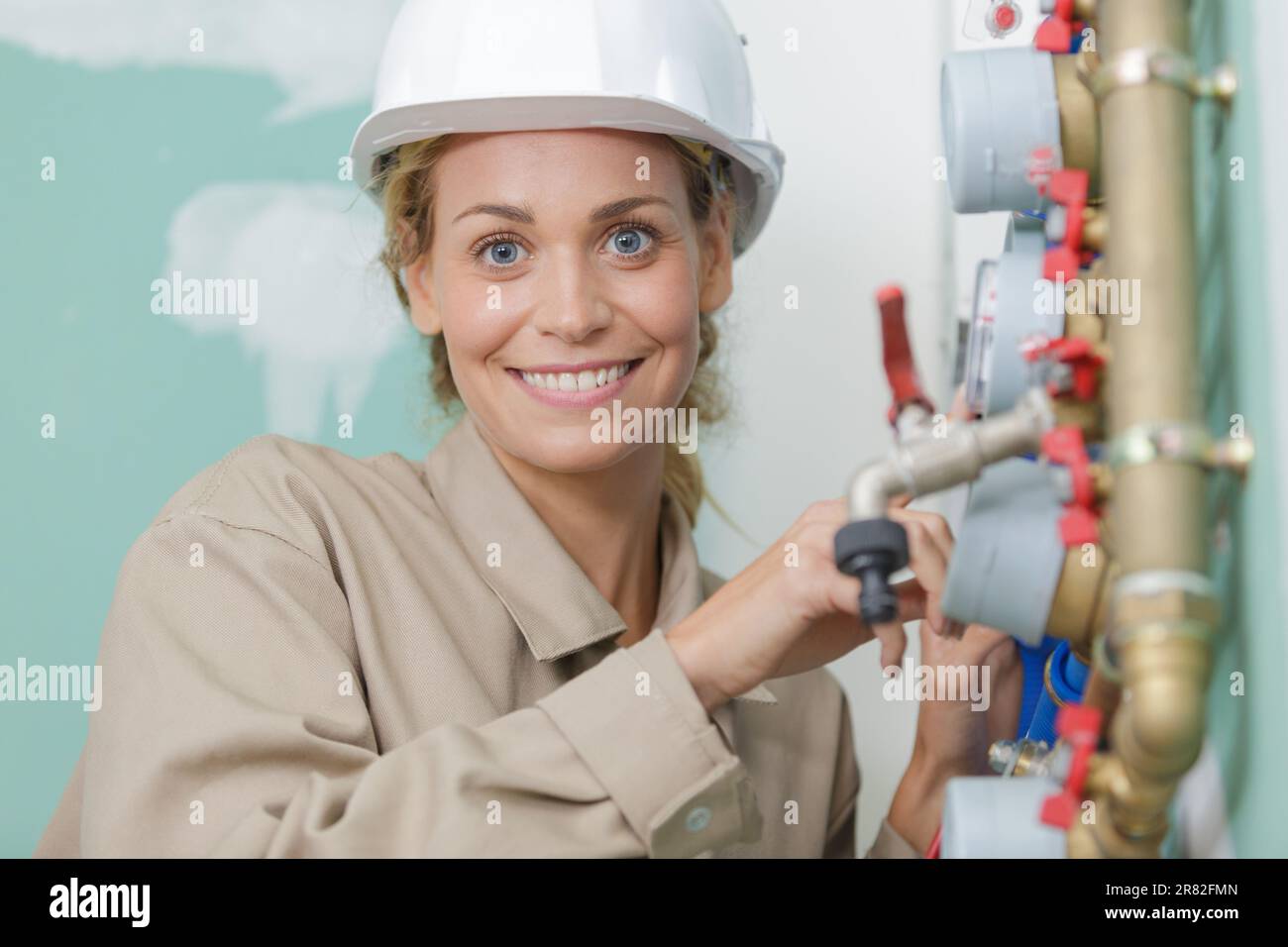 female builder working with water meters Stock Photo - Alamy