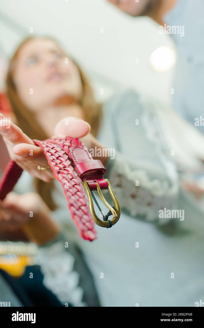 a lady is holding belt Stock Photo - Alamy