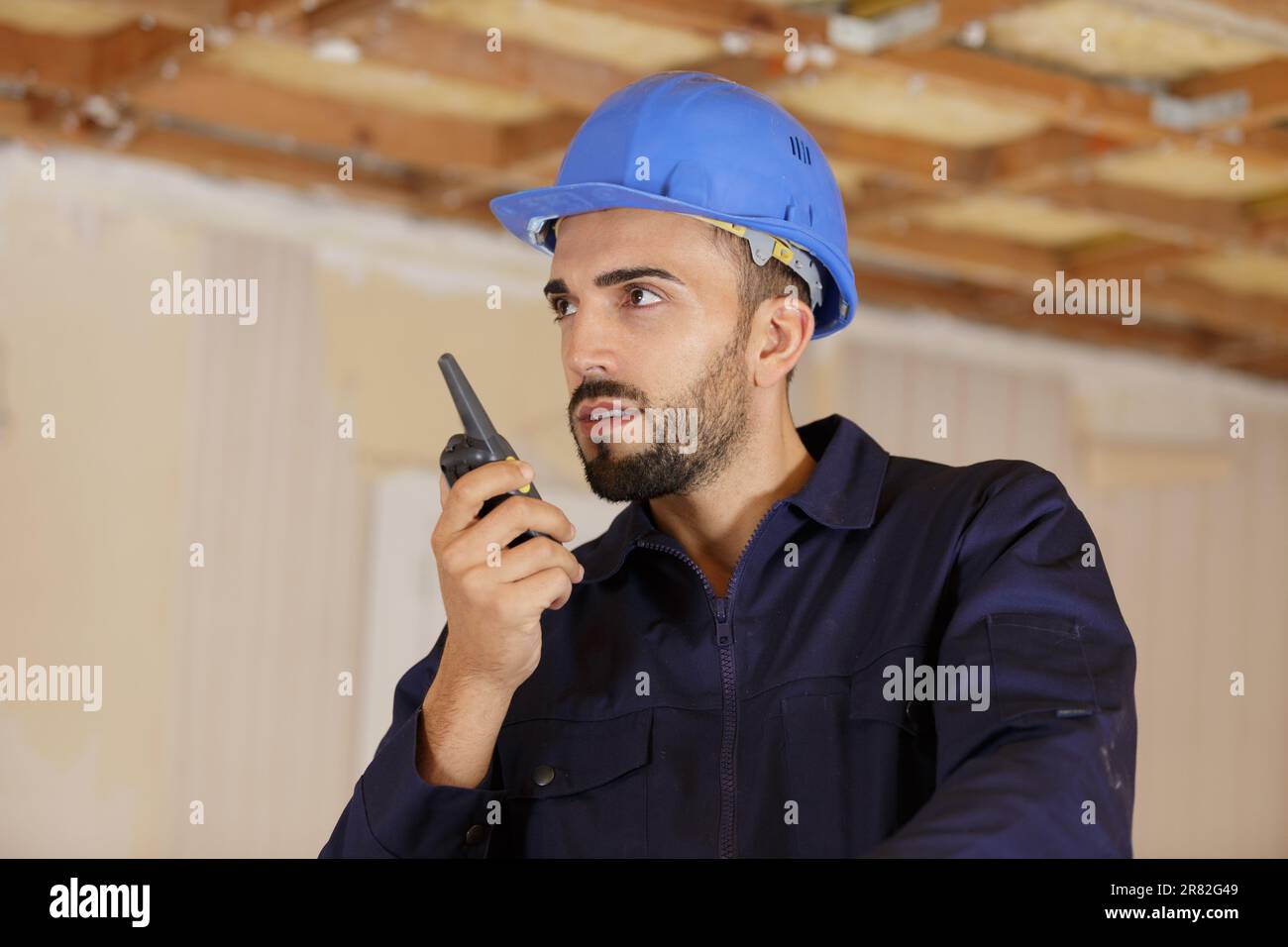 man talking into walkie talkie Stock Photo - Alamy