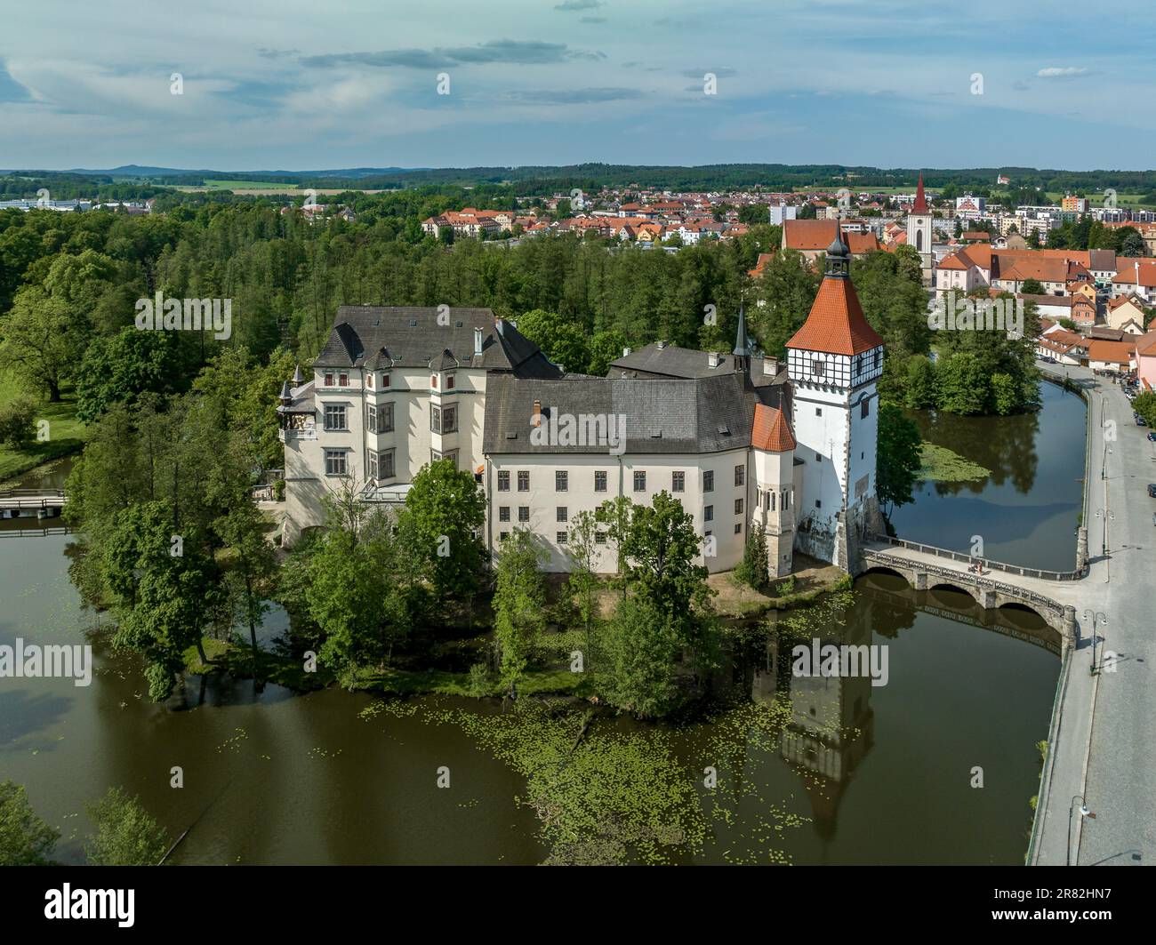 Aerial view of Blatna medieval water castle with towers, turrets, plus ...