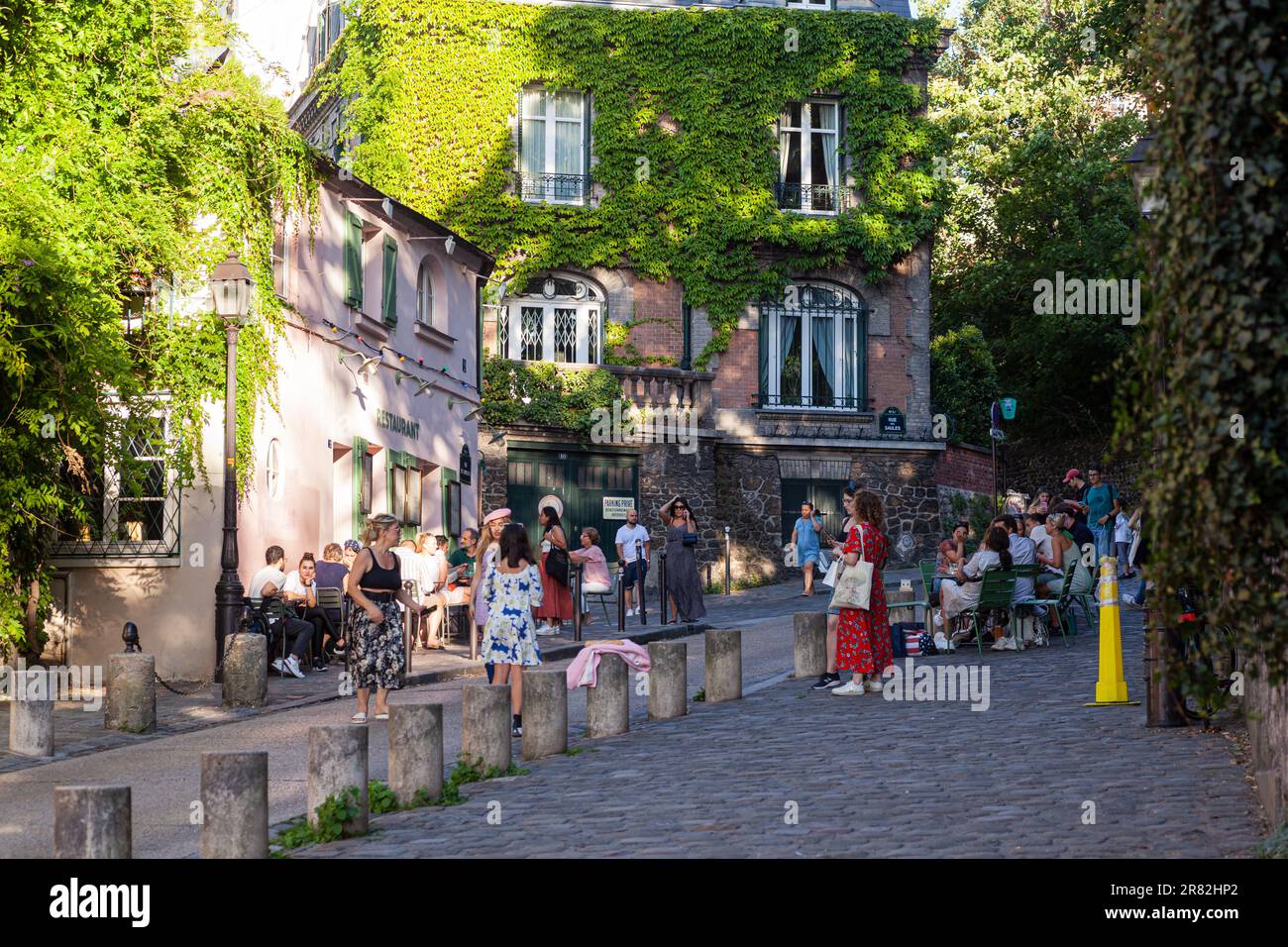 Paris, France - July, 15: Cozy old street with pink house restaurant ...