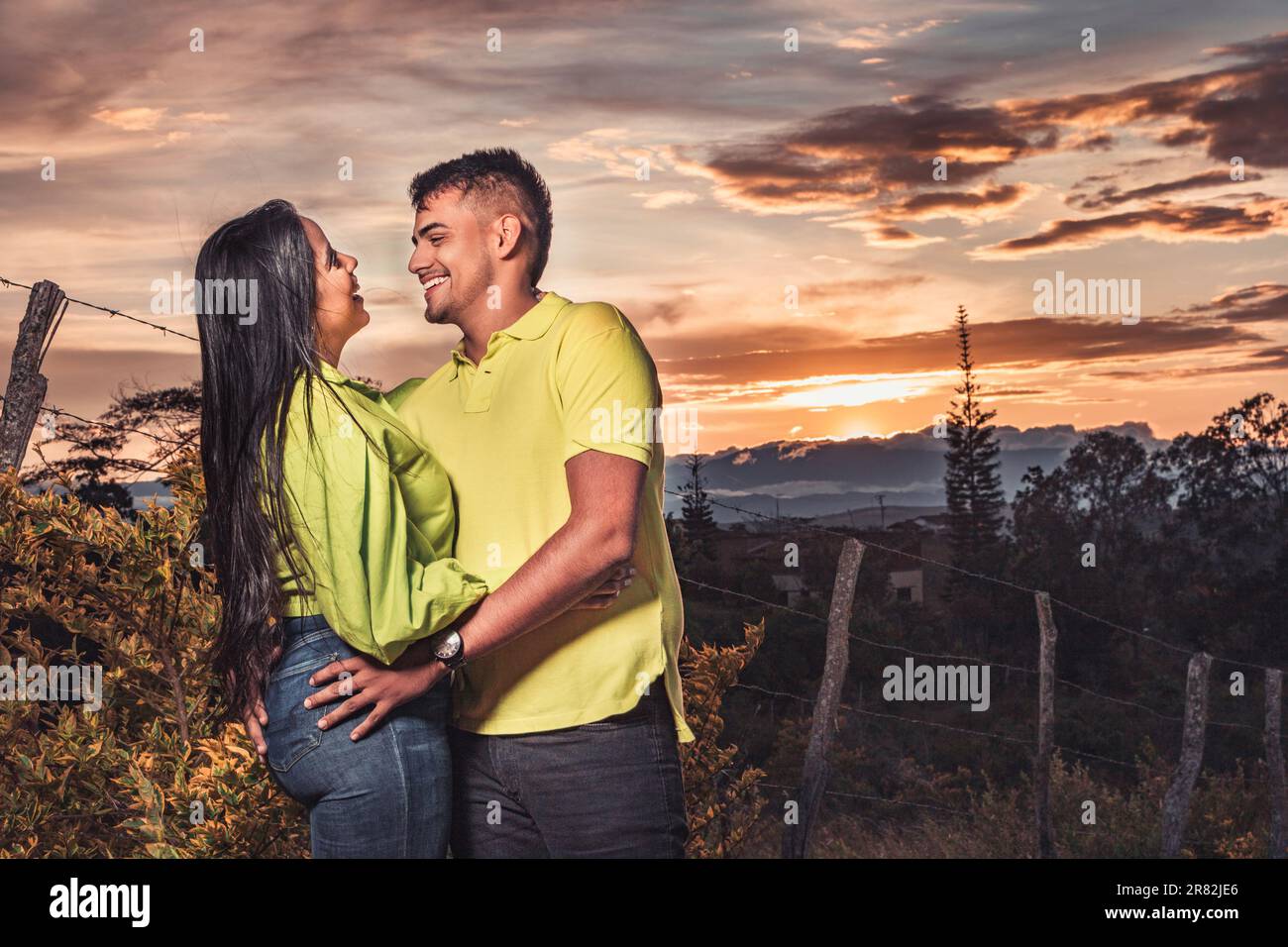A moment between a happy couple as they look lovingly into each other's ...