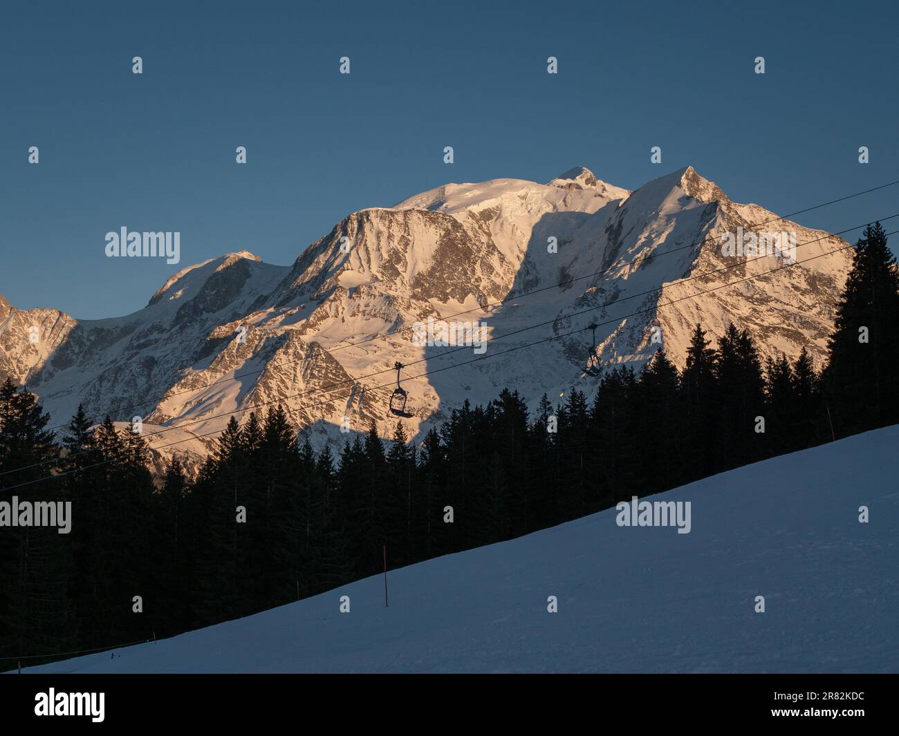 A majestic snow-capped Mont Blanc mountain range, with lush evergreen ...