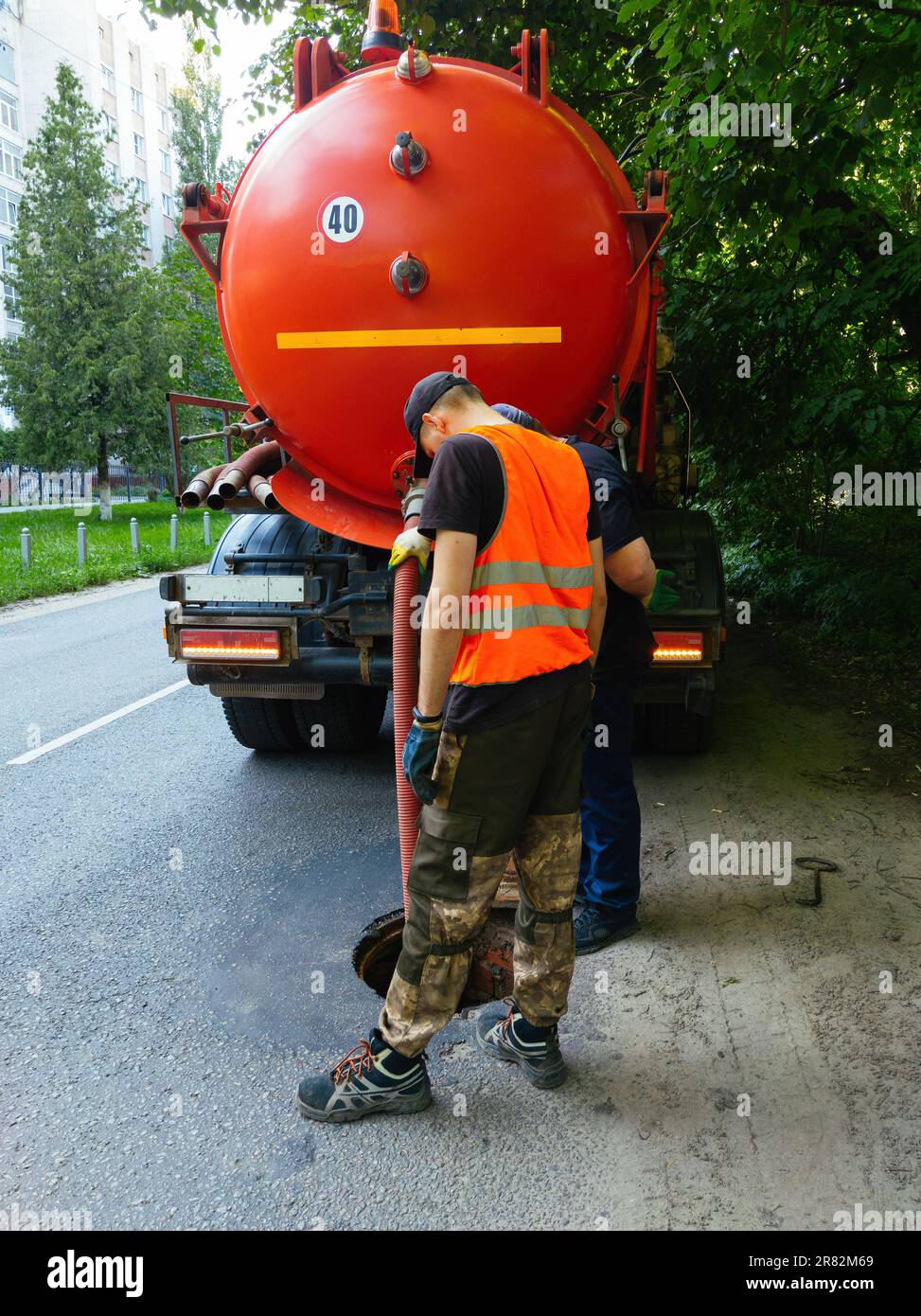 Sewer workers cleaning manhole and unblocking sewers the street ... Sewer workers cleaning manhole and unblocking sewers the street ...