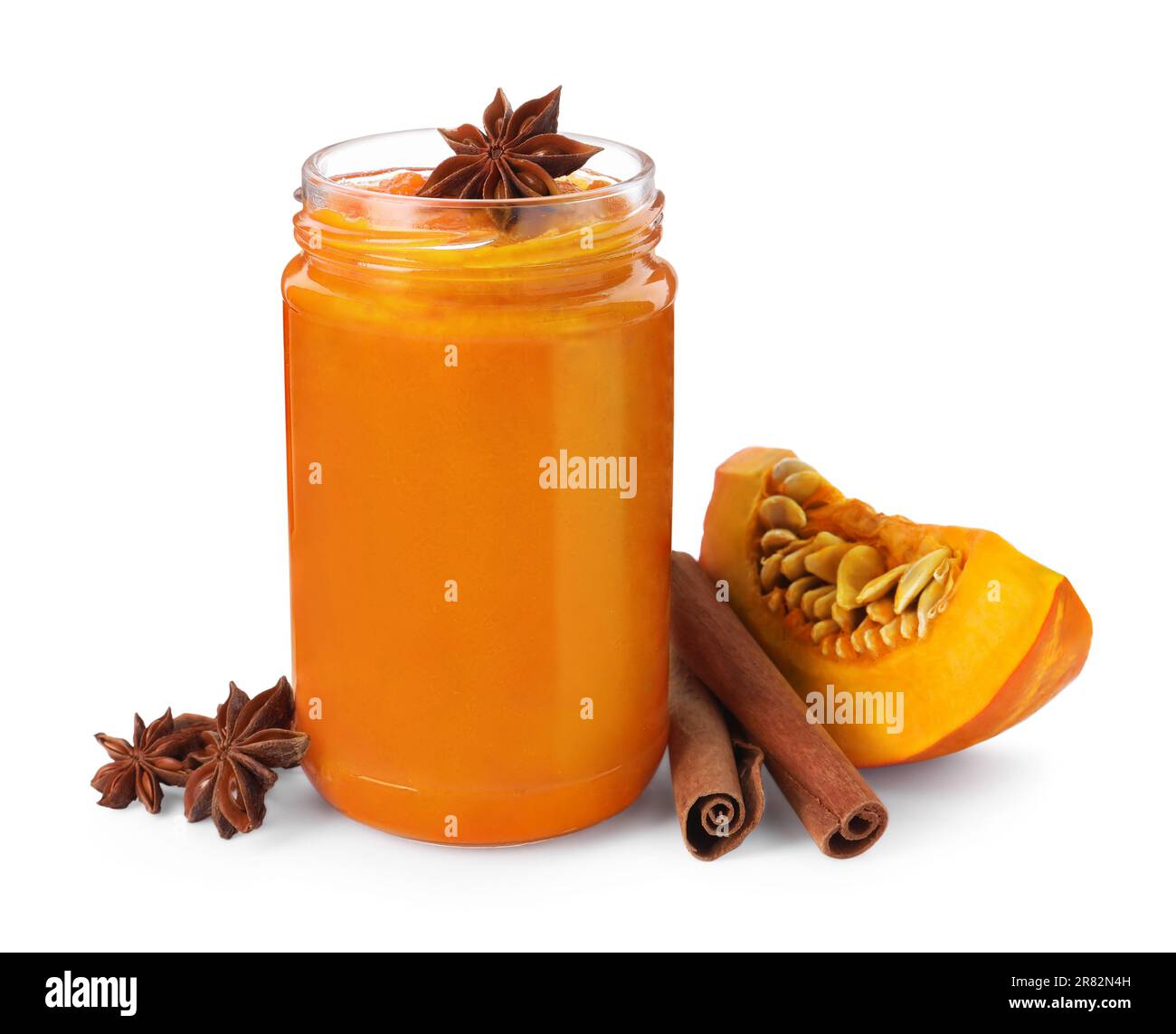 Jar of pumpkin jam, star anise, fresh pumpkin and cinnamon on white ...