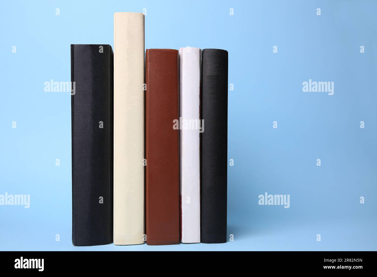 Collection of books on light blue background, space for text Stock ...